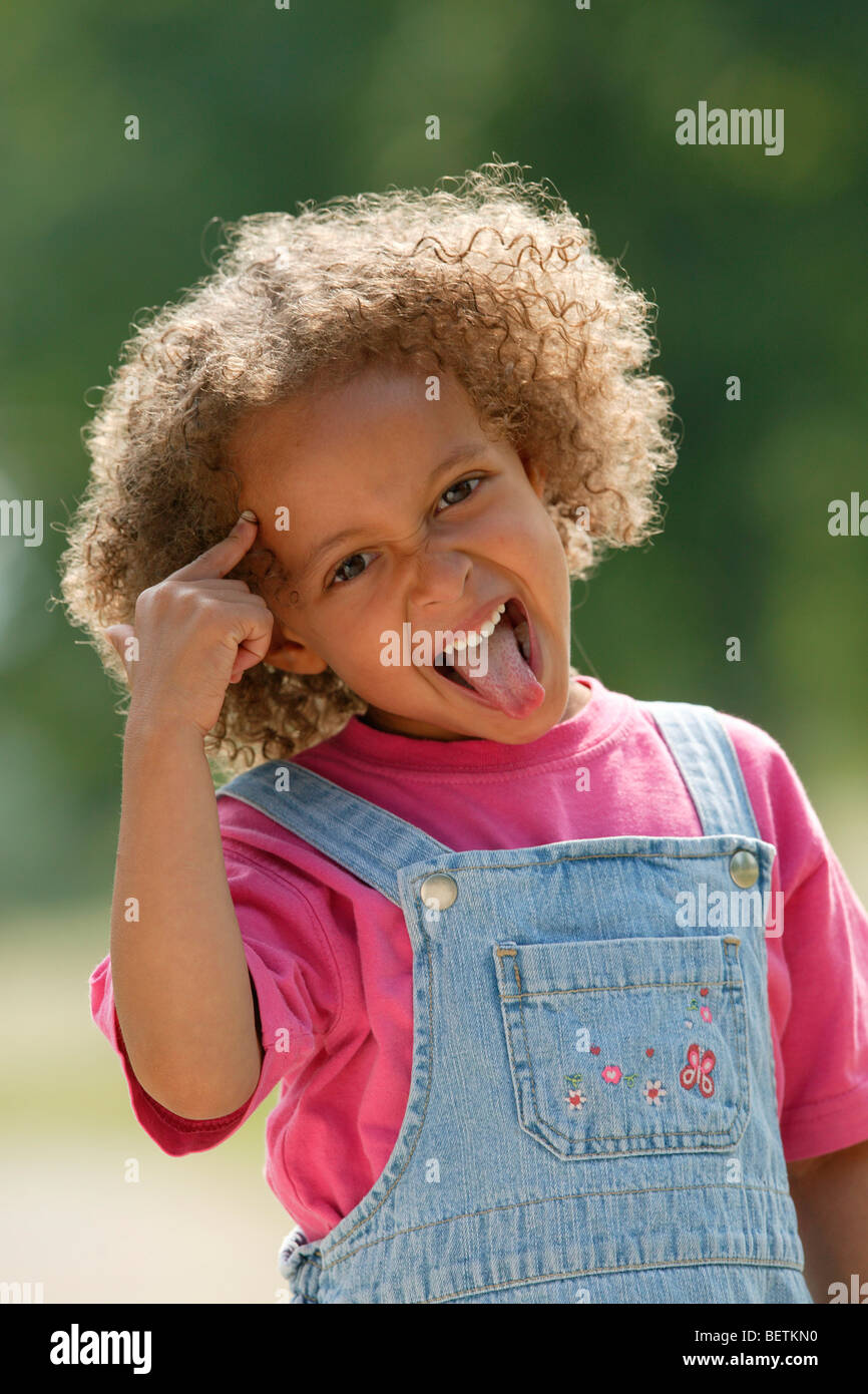 Child pulling face sticking tongue hi-res stock photography and images ...