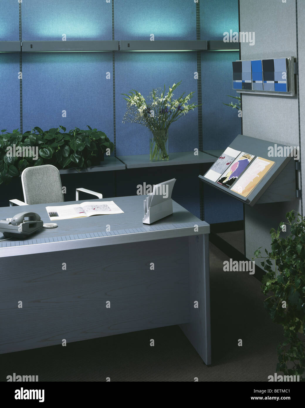 Telephone on grey desk in small modern office Stock Photo - Alamy