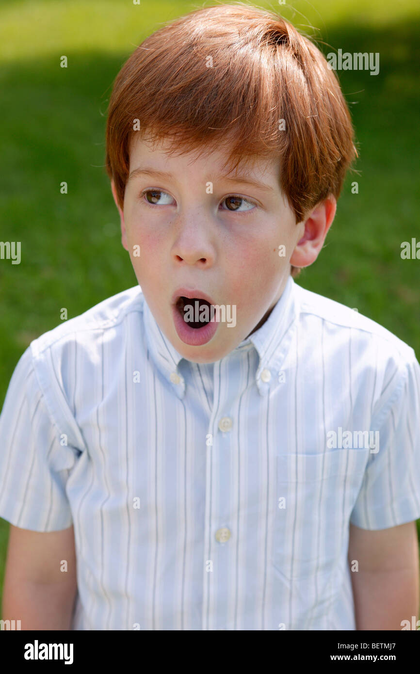 young boy outdoors looking shocked Stock Photo - Alamy