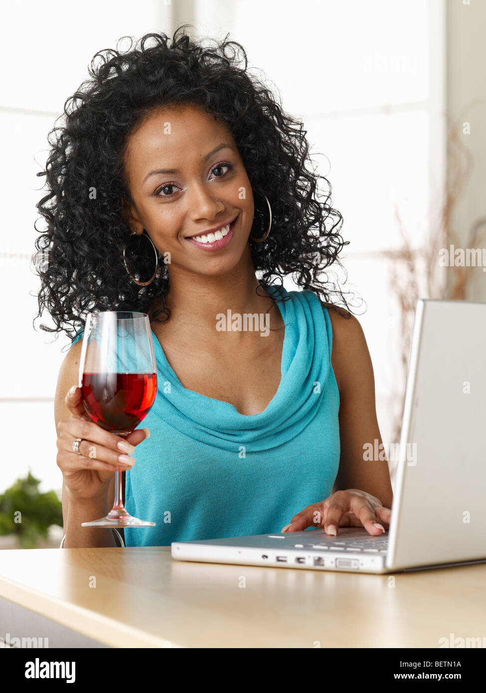 Young woman working with laptop computer while drinking wine Stock ...