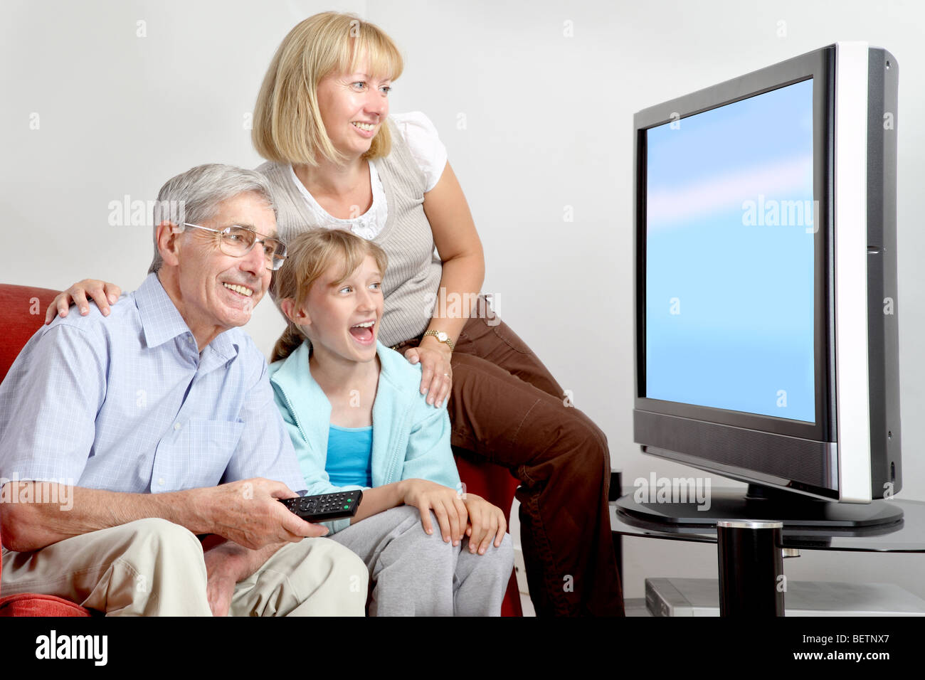 Three generations family watching tv hi-res stock photography and ...