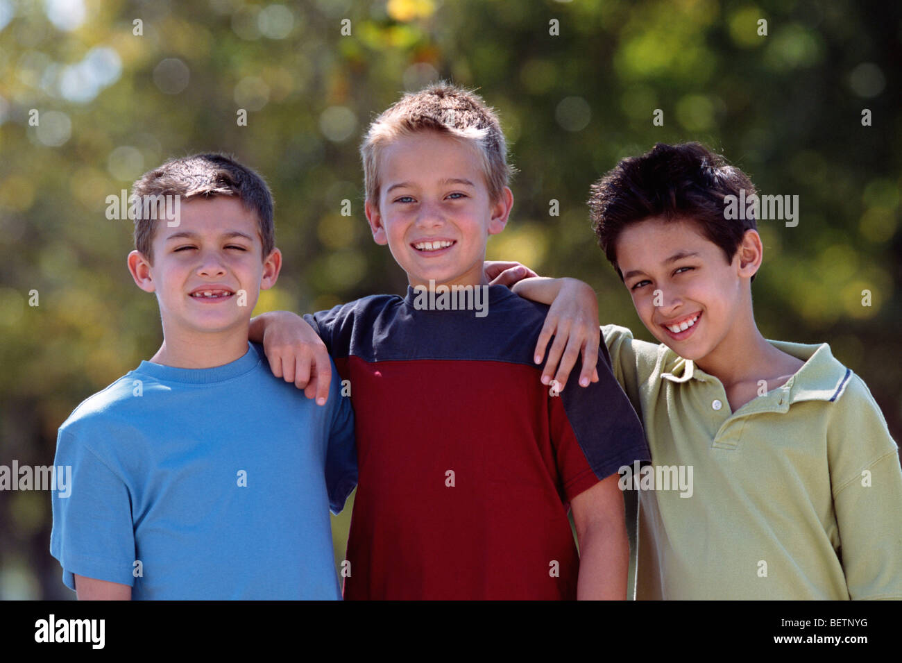 three young boys outside smiling at the camera Stock Photo - Alamy