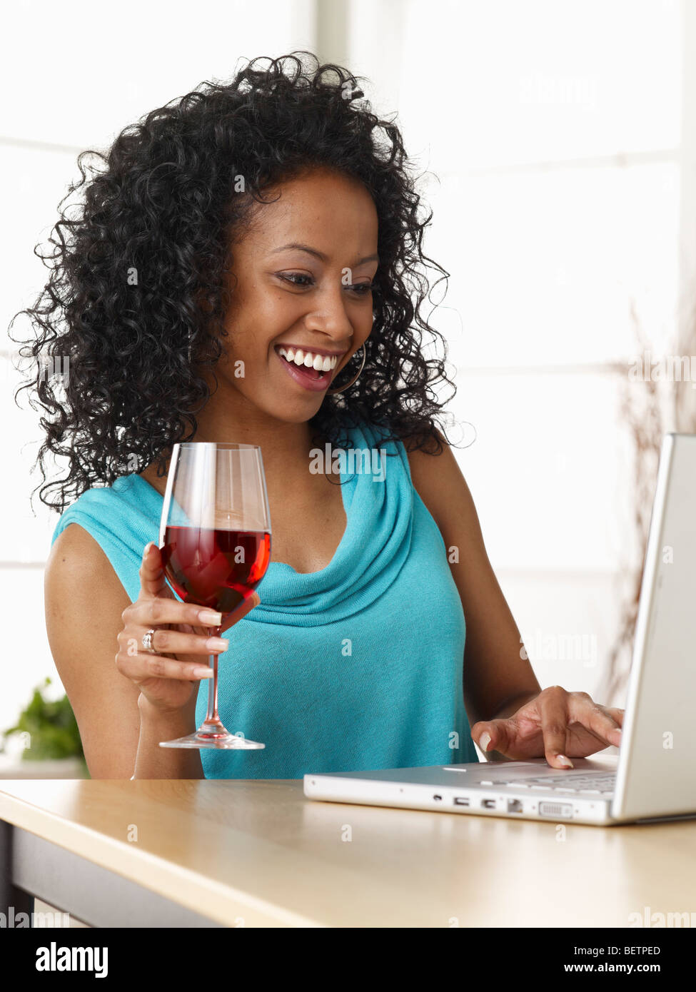 Young woman working with laptop computer while drinking wine Stock ...
