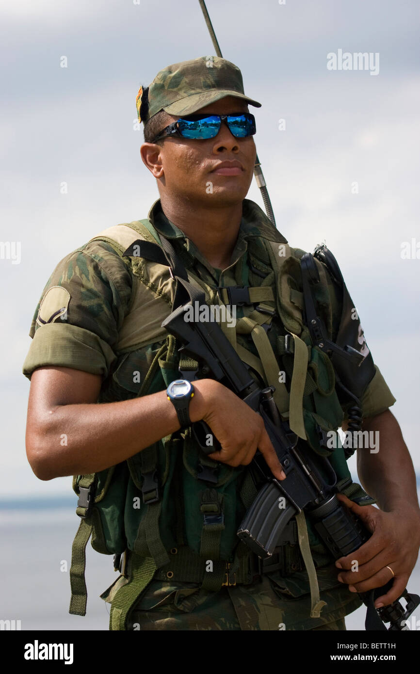a heavily armed Brazilian marine stands guard during a military ...
