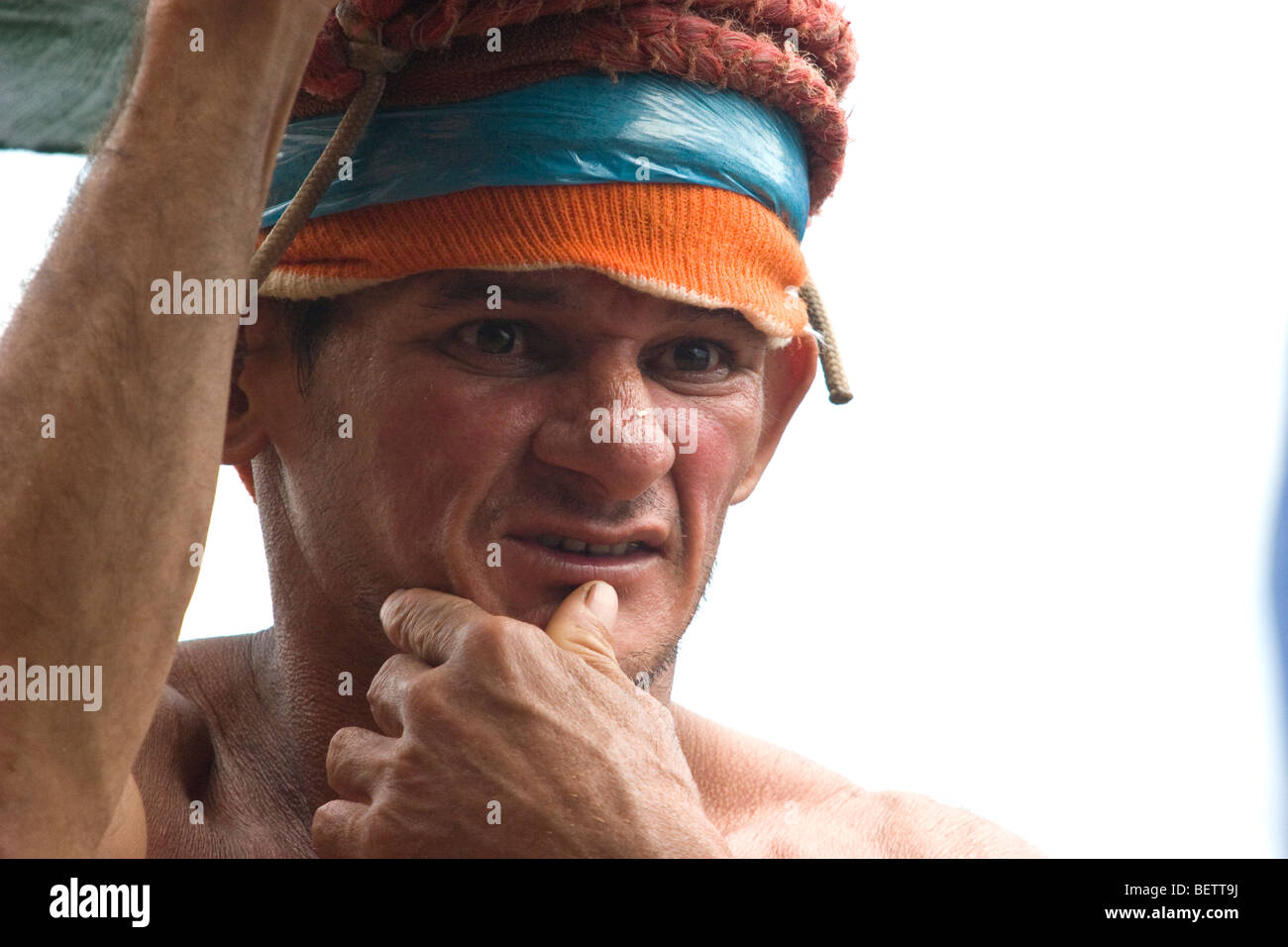 a dock worker looks confused where to go while working as a porter on ...