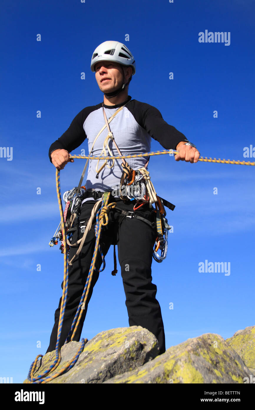 Rock Climber against clear blue sky Stock Photo - Alamy