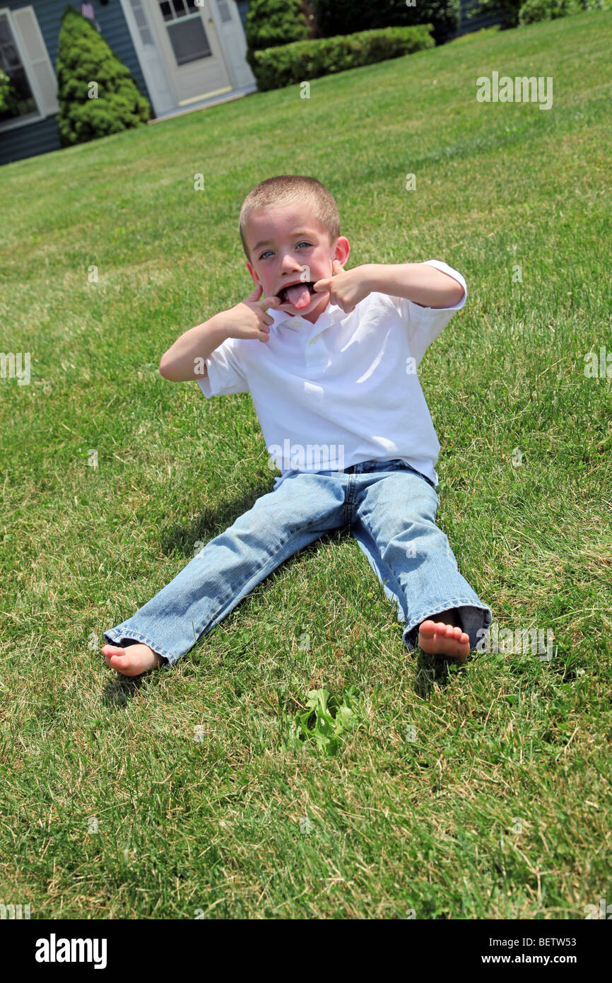 Small boy pulling a funny face Stock Photo - Alamy