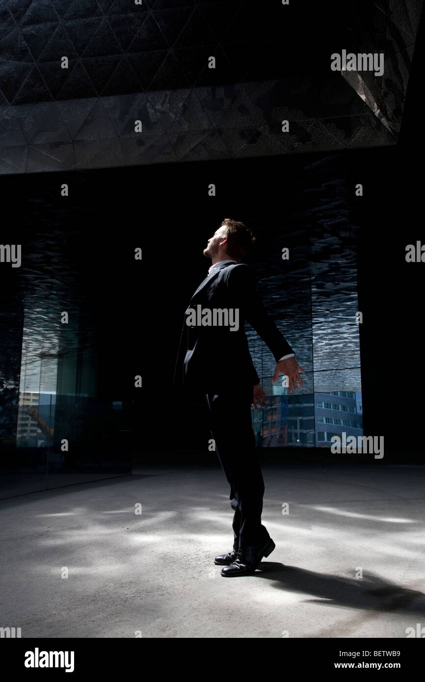 businessmen getting pulled up by unseen force Stock Photo - Alamy