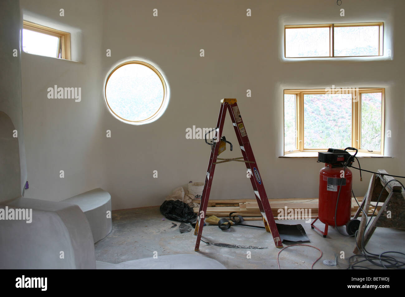 final stage of building a modern home, round window, light, painting ...