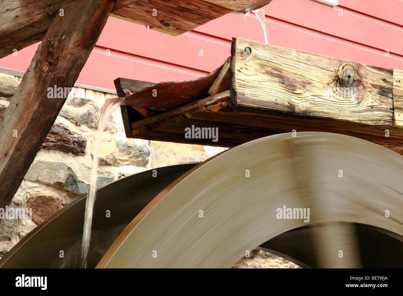 A spinning water wheel showing motion blur Stock Photo - Alamy