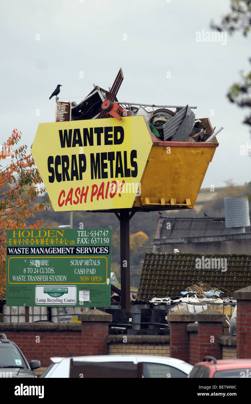 A skip full of scrap metal held aloft to advertise a scrap metal yard ...