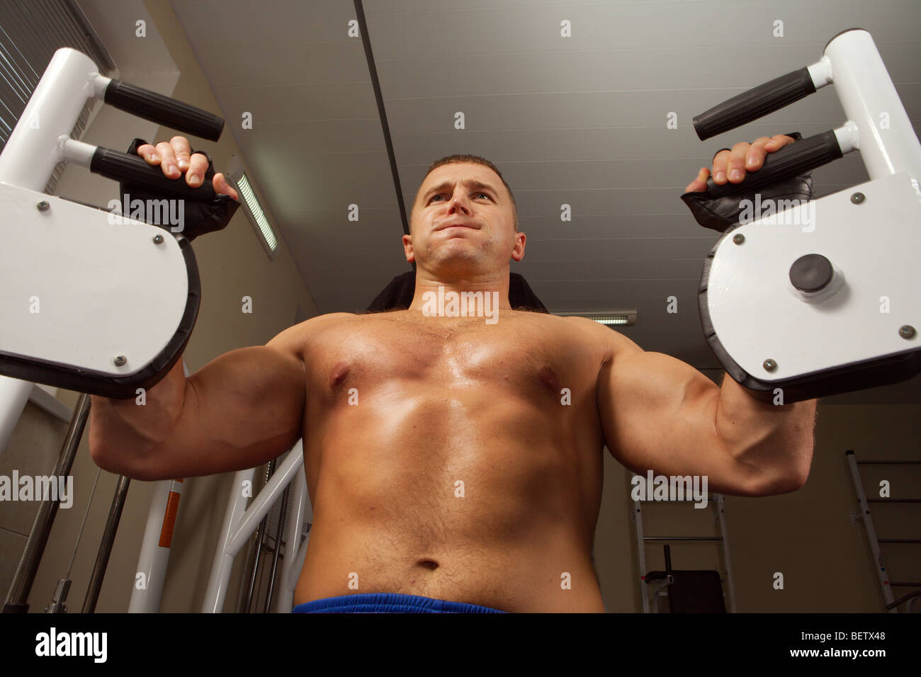 Man makes exercises for increase in force of muscles Stock Photo - Alamy