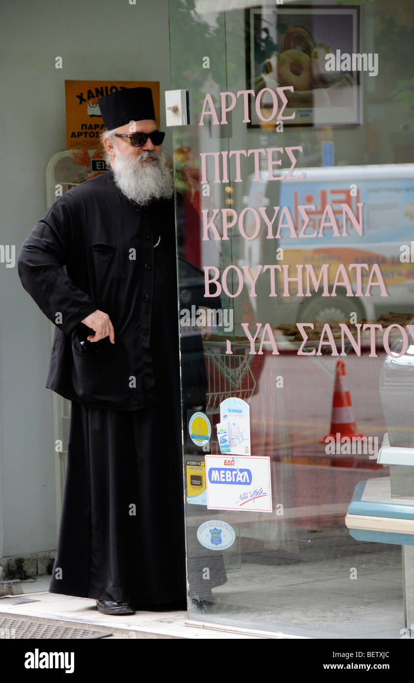 Greek priest seen in a bakers shop doorway central Thessaloniki ...