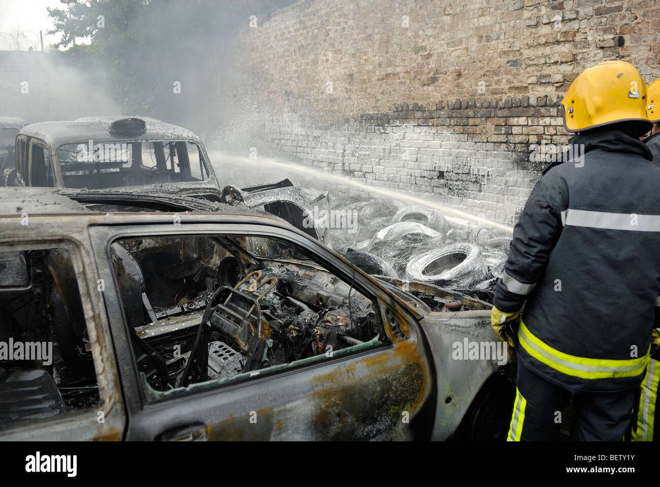 Car scrapyard on fire full of hackney cab taxis Stock Photo - Alamy