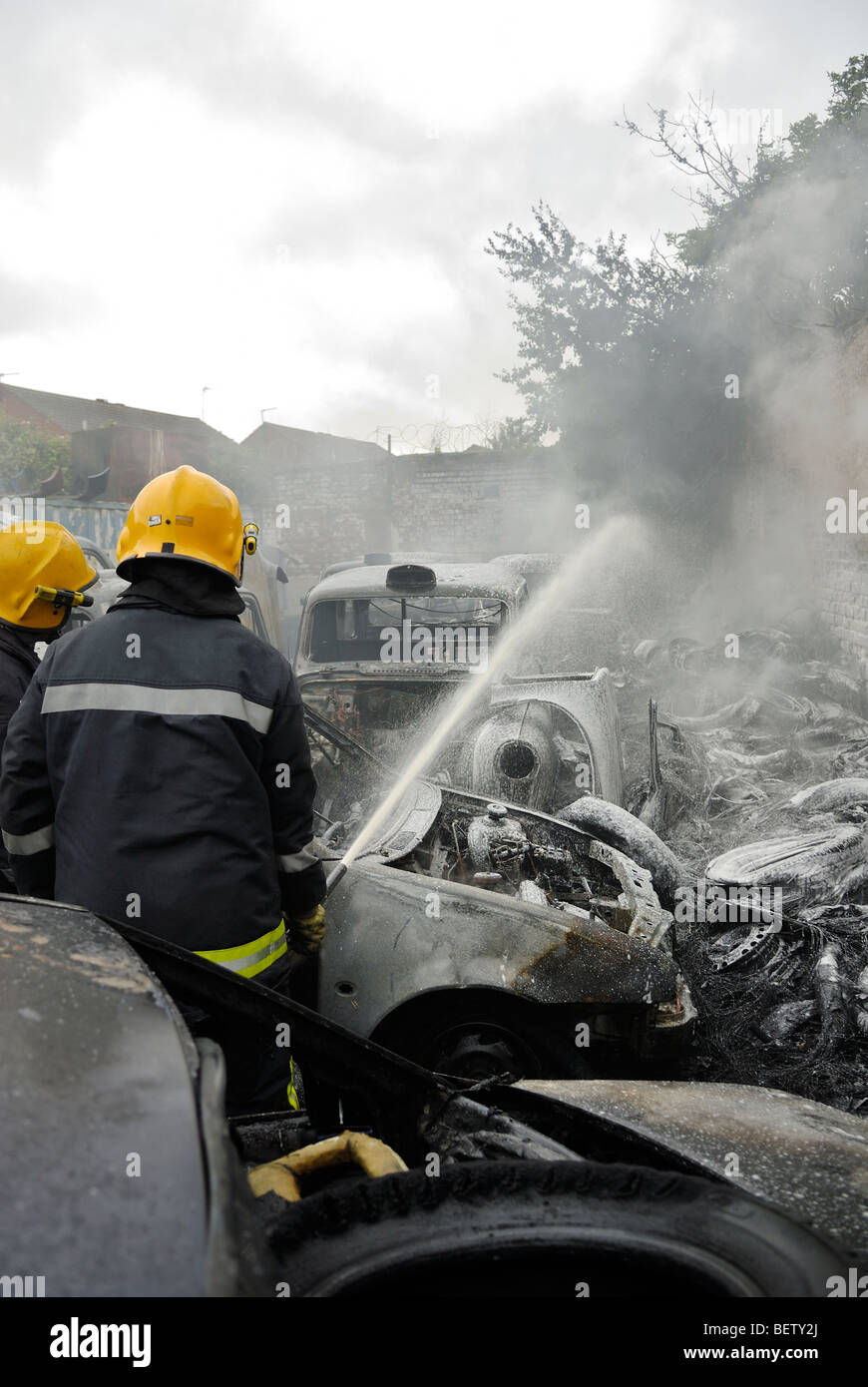 Car scrapyard on fire full of hackney cab taxis Stock Photo - Alamy