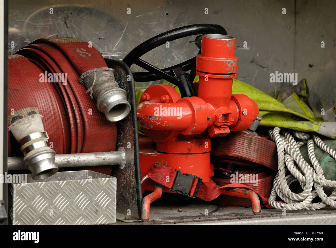 Ground monitor and hose in fire engine locker Stock Photo - Alamy
