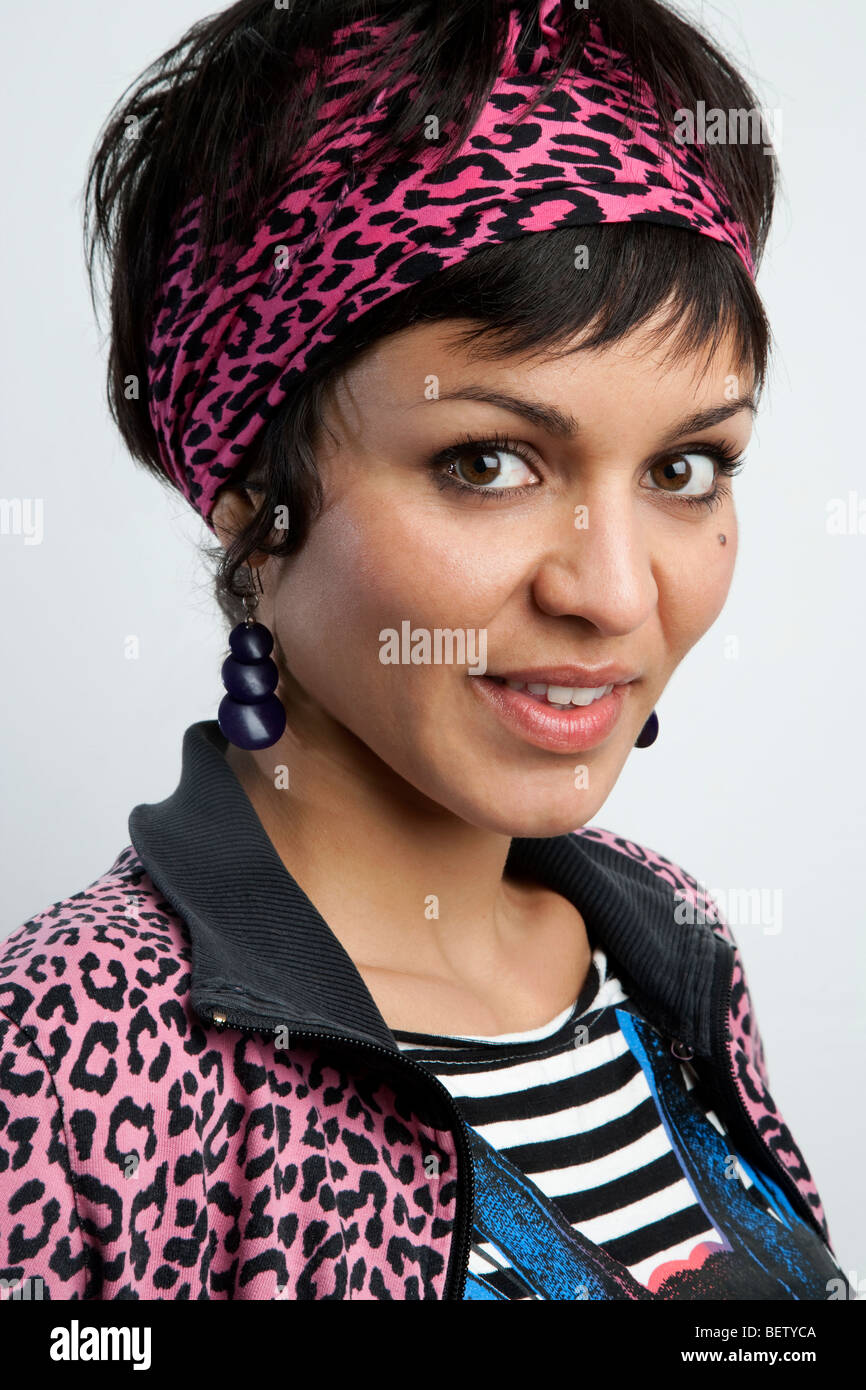 Beautiful colorful young woman looking at the camera Stock Photo - Alamy