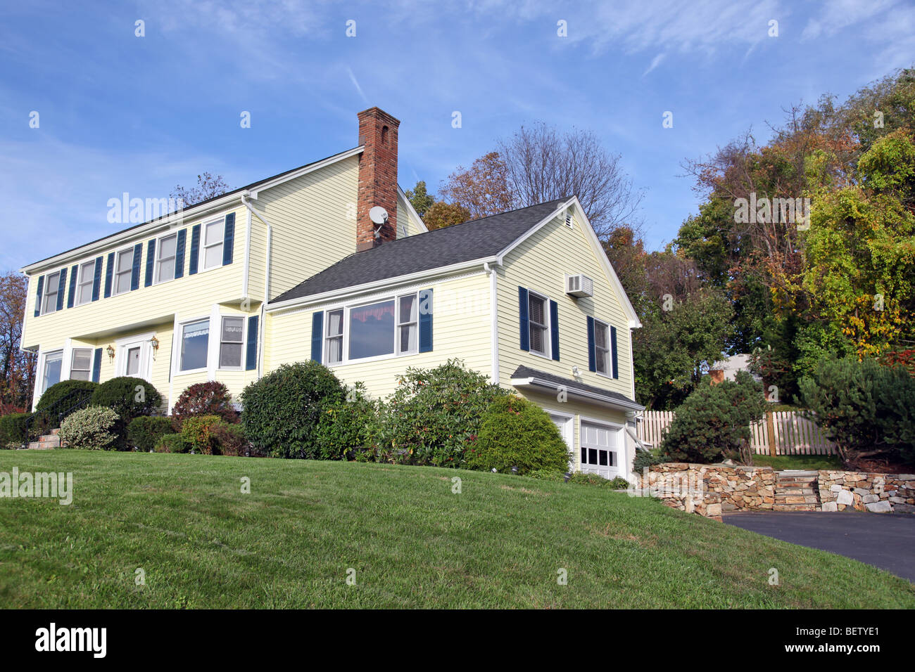 Yellow New England Style colonial house Stock Photo - Alamy
