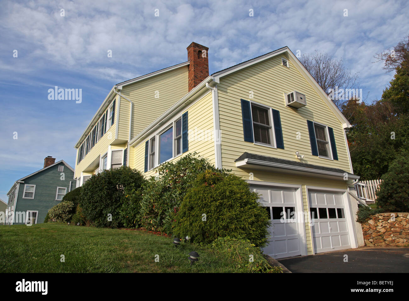 Yellow New England Style colonial house Stock Photo - Alamy