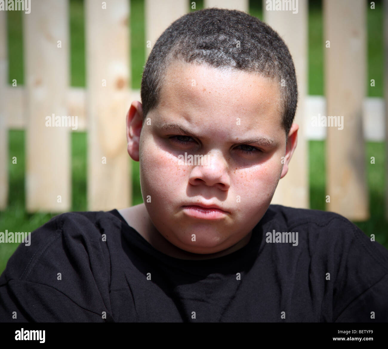 Unhappy boy outside in sunshine portrait Stock Photo - Alamy