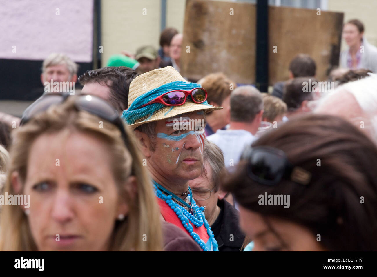 Portrait of a samba school man wearing a straw hat and a painted face ...