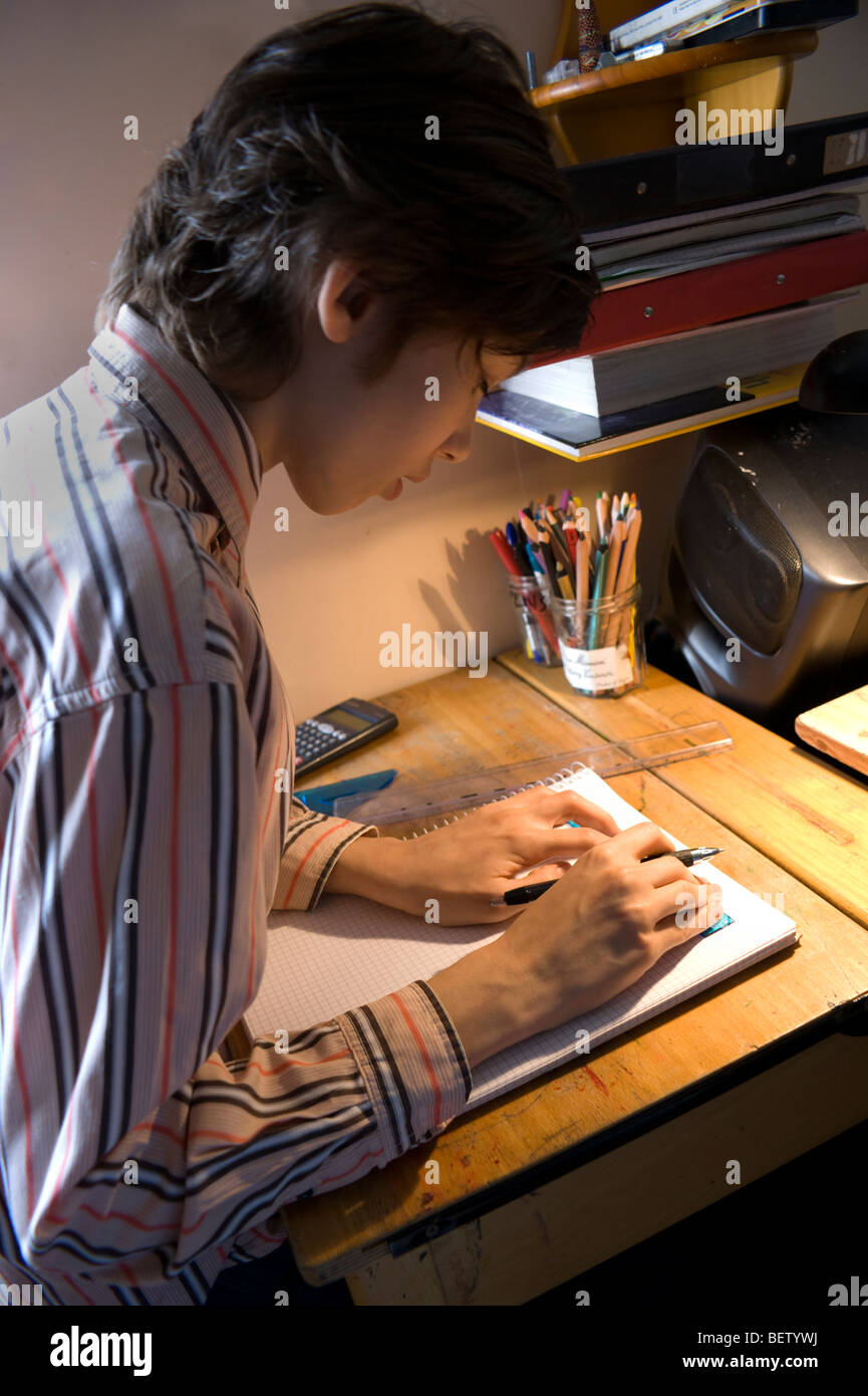 12 year old boy engaged in home learning /homework Stock Photo - Alamy