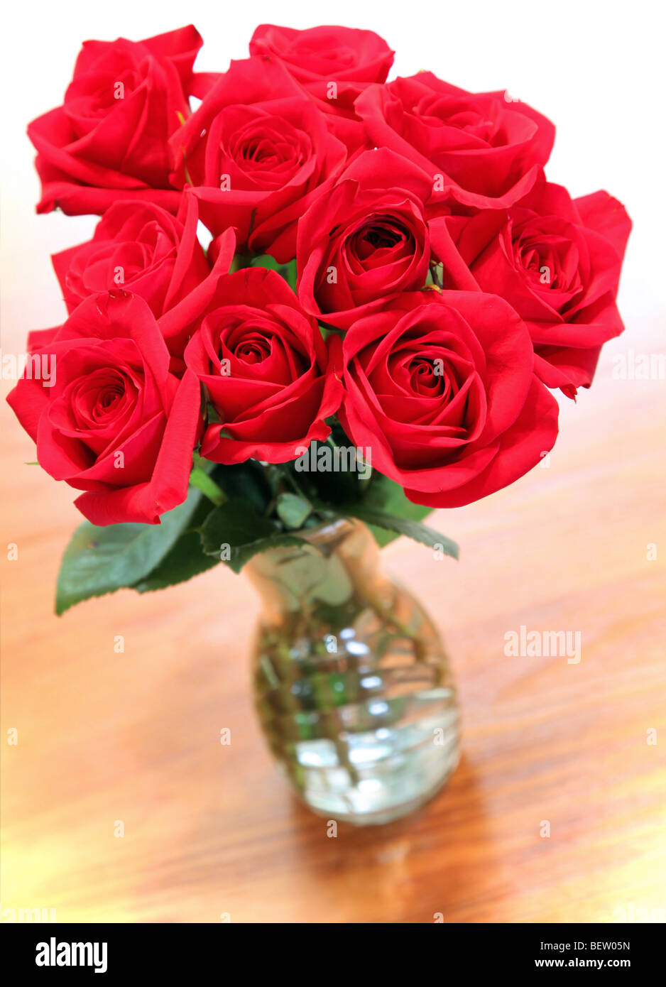 Bright red roses in a glass vase Stock Photo - Alamy