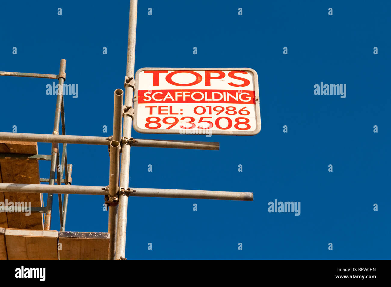 A sign advertising TOPS scaffolding in the Uk Stock Photo - Alamy