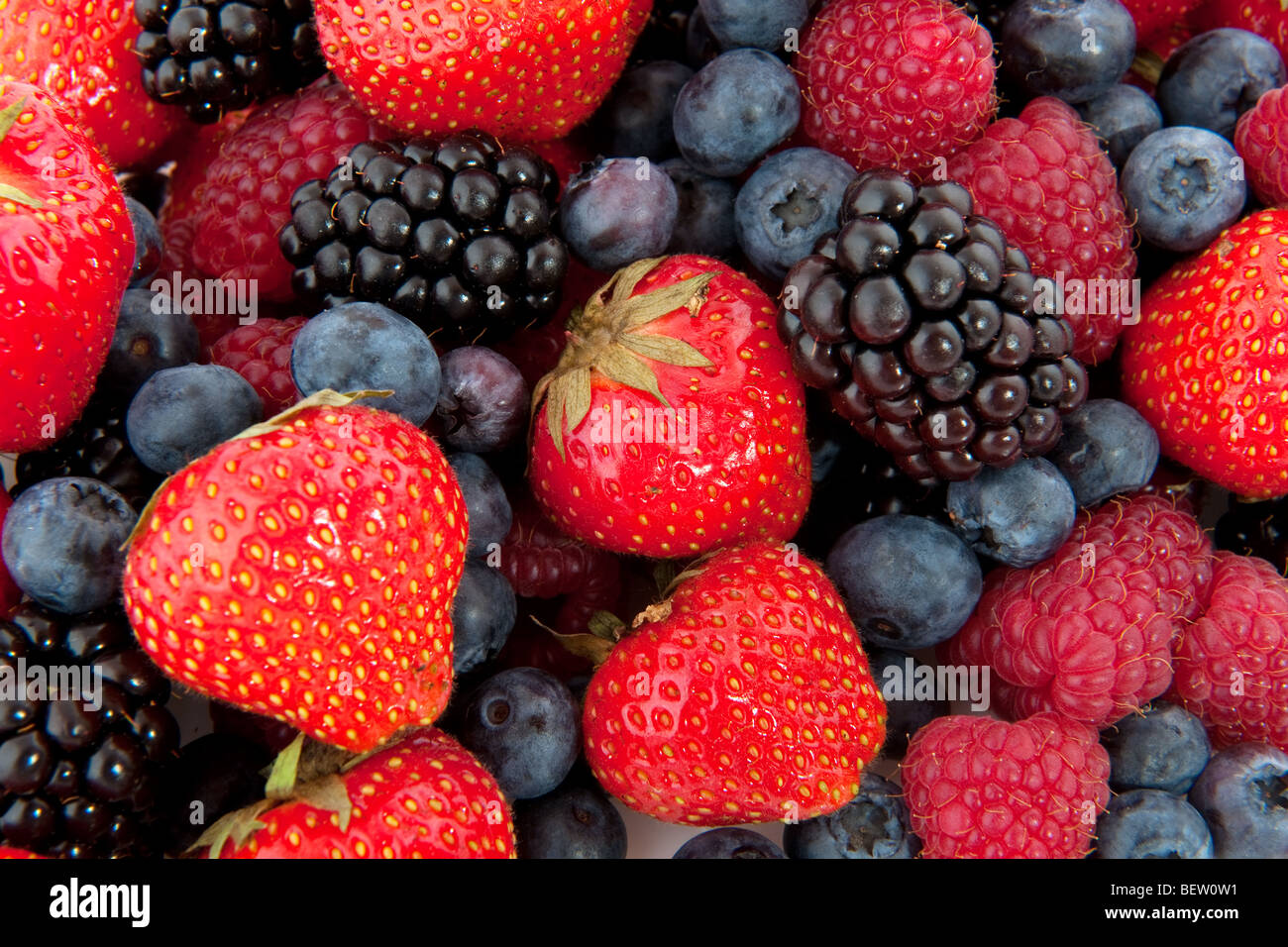 Diversity fresh forest fruit full as a background Stock Photo - Alamy