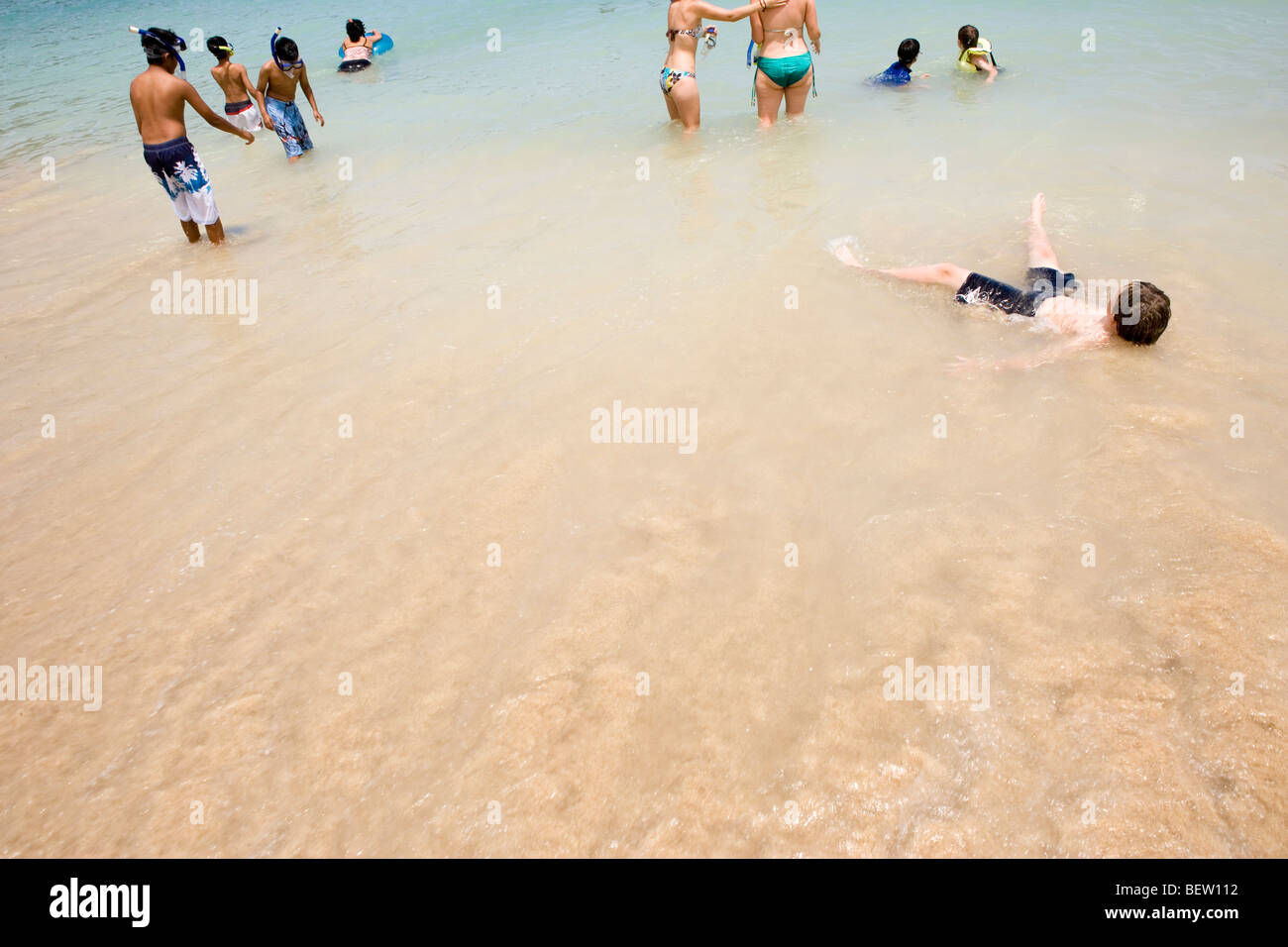 boy floating in shallow beach water, Honolulu, Hawaii Stock Photo - Alamy
