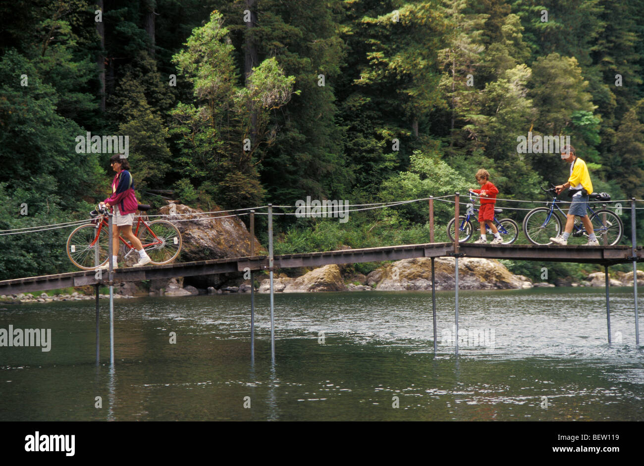 Family with bicycles on bridge over Smith River at Jedediah Smith ...