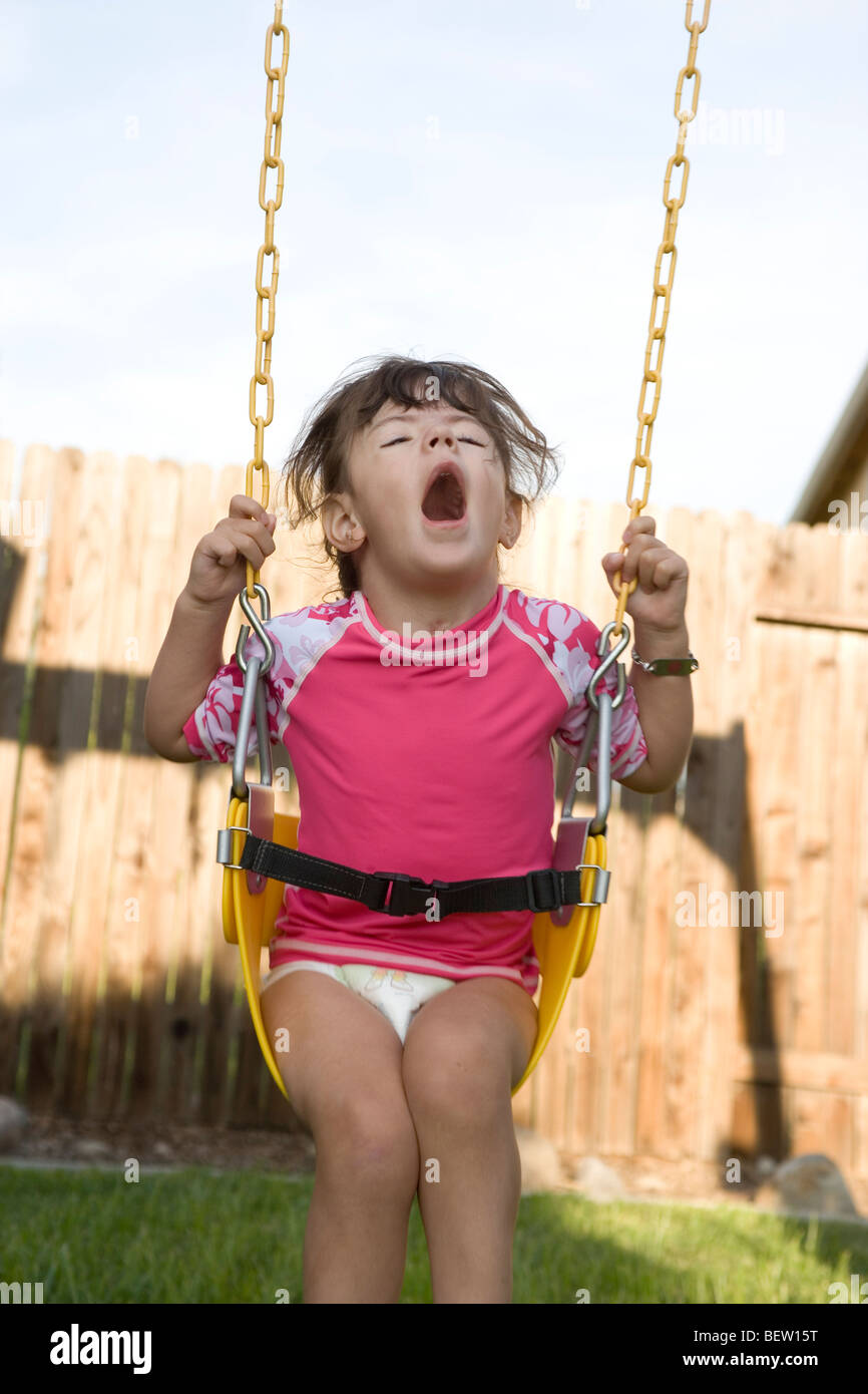 child with myotonic muscular dystrophy sits on a swing and yells for ...