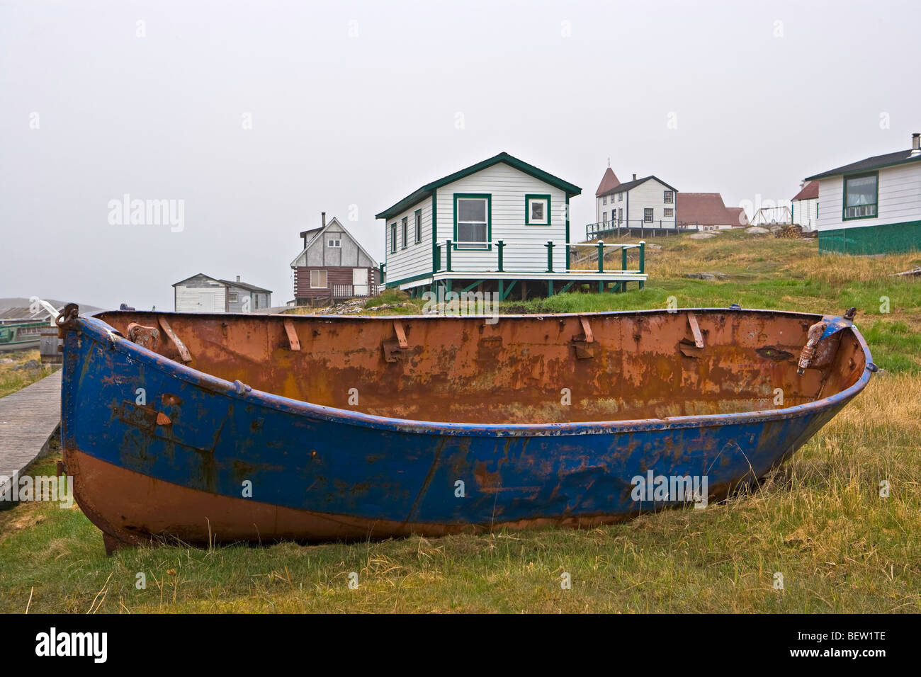 An old fishing boat hauled out on the shore at Battle Harbour,Battle ...