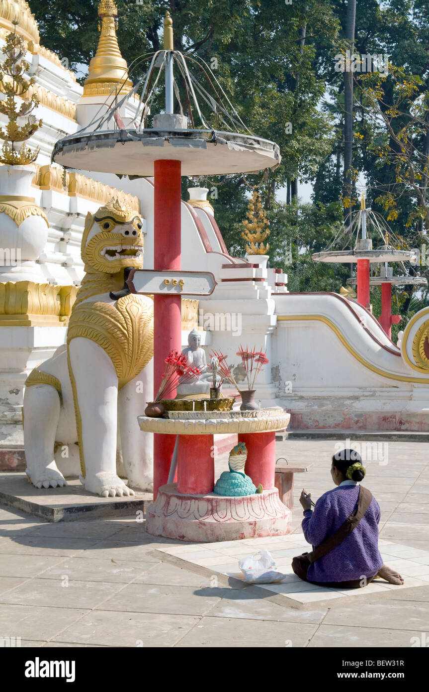 MYANMAR (BURMA) WOMAN PRAYING AT A BUDDHIST TEMPLE IN THE HOLY CITY OF ...