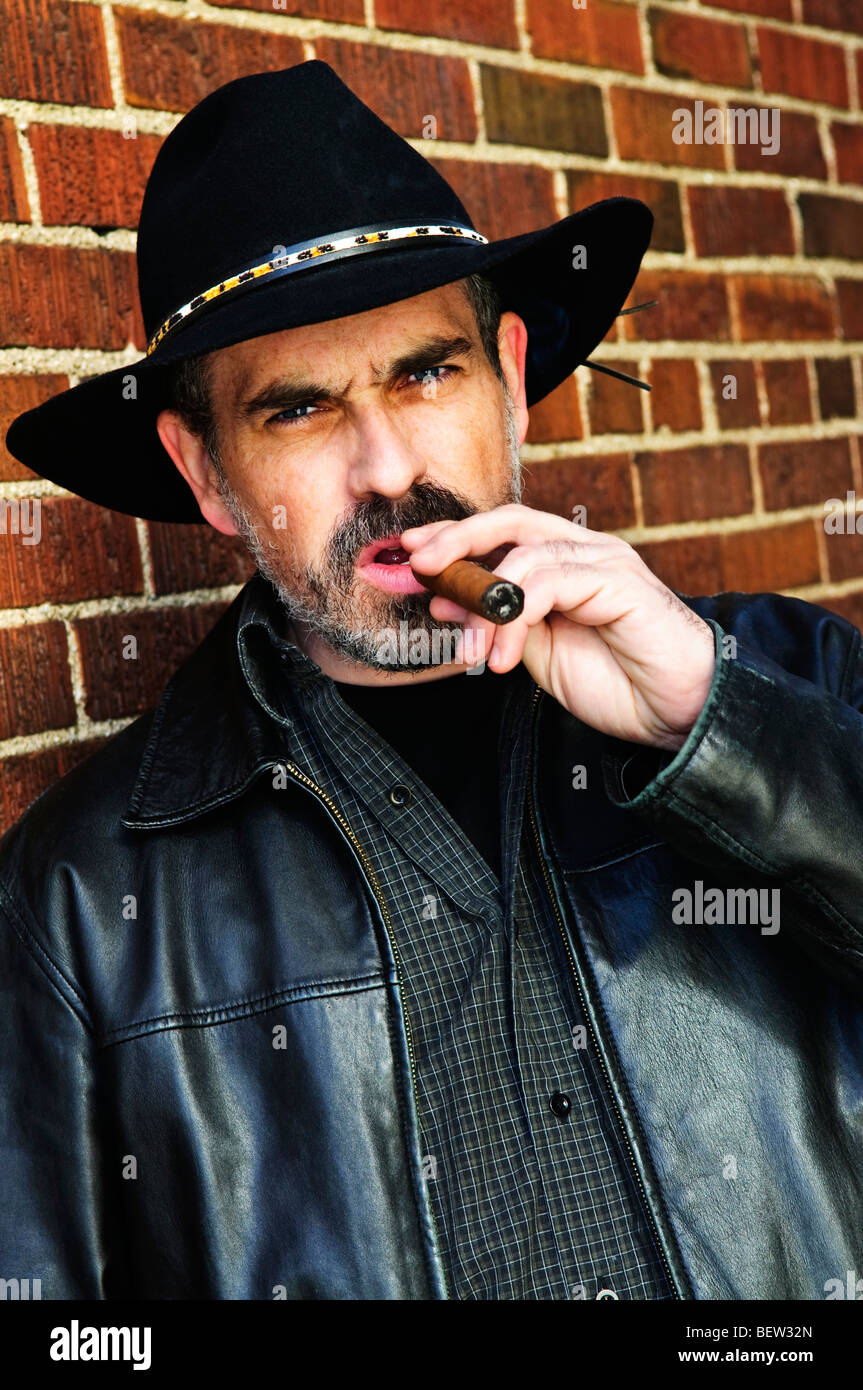 Man with beard in cowboy hat smoking cigar Stock Photo - Alamy