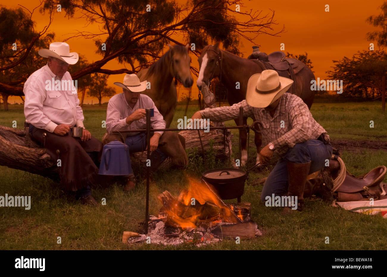 Three cowboys sitting side by side, full shot, USA Stock Photo - Alamy