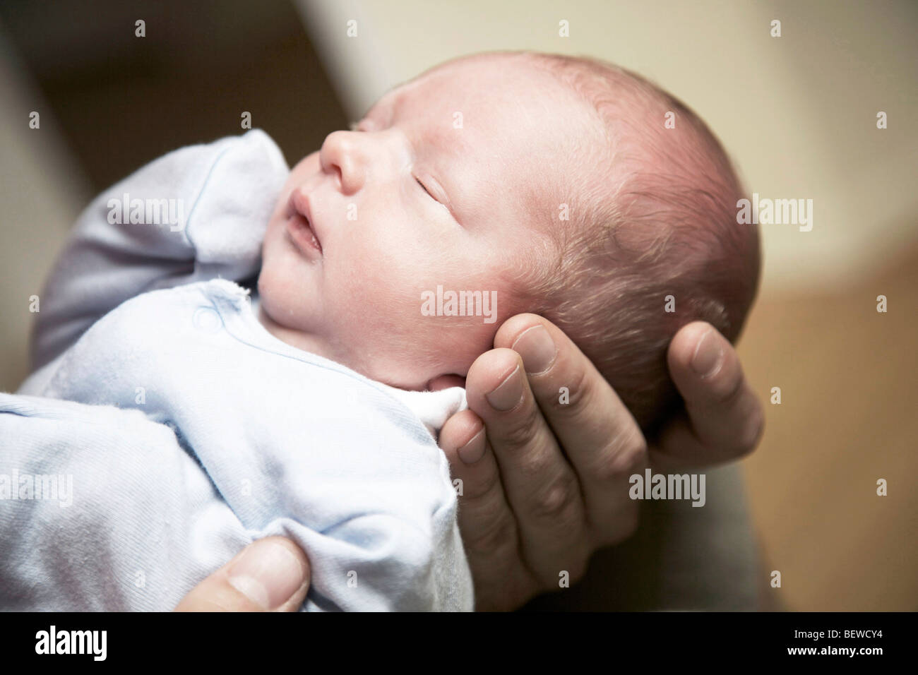 Man holding a sleeping baby in his hands, close-up Stock Photo - Alamy