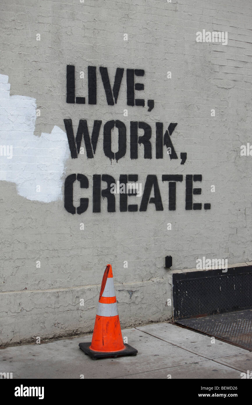 Traffic cone in front of a wall with stencil lettering, New York City ...