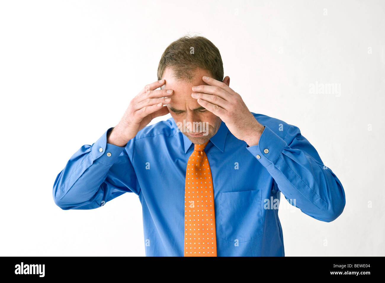 Businessman holding hands on his forehead Stock Photo - Alamy