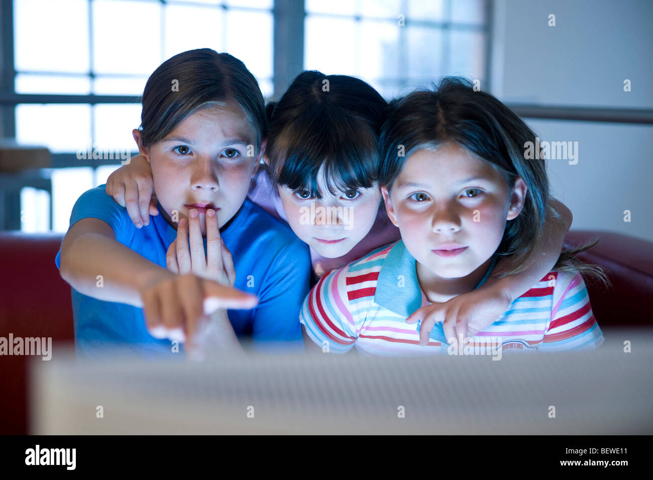 Three girls sitting in front of a computer, front view Stock Photo - Alamy