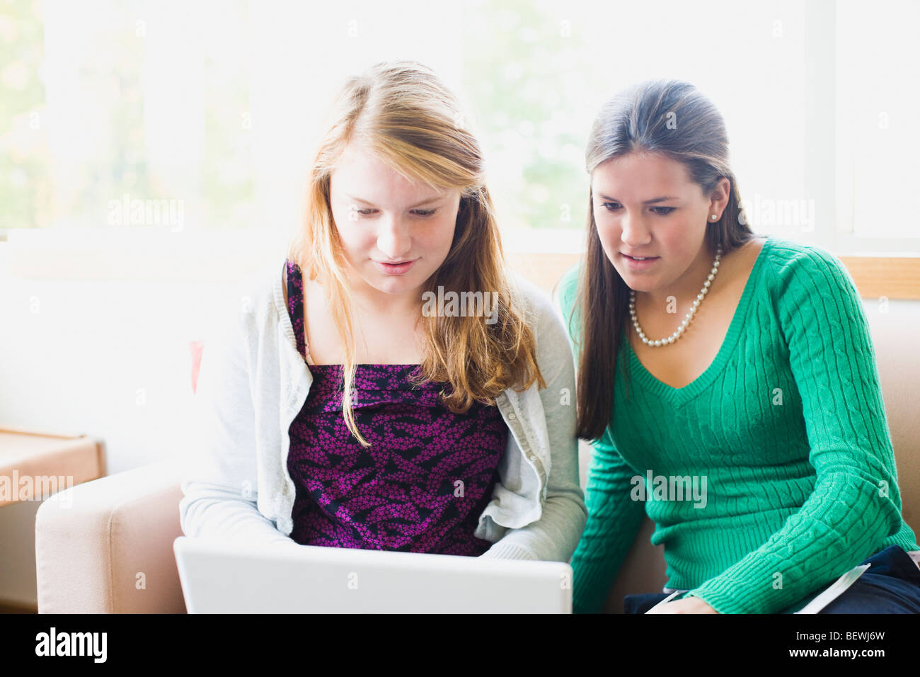 Two students working on a laptop Stock Photo - Alamy