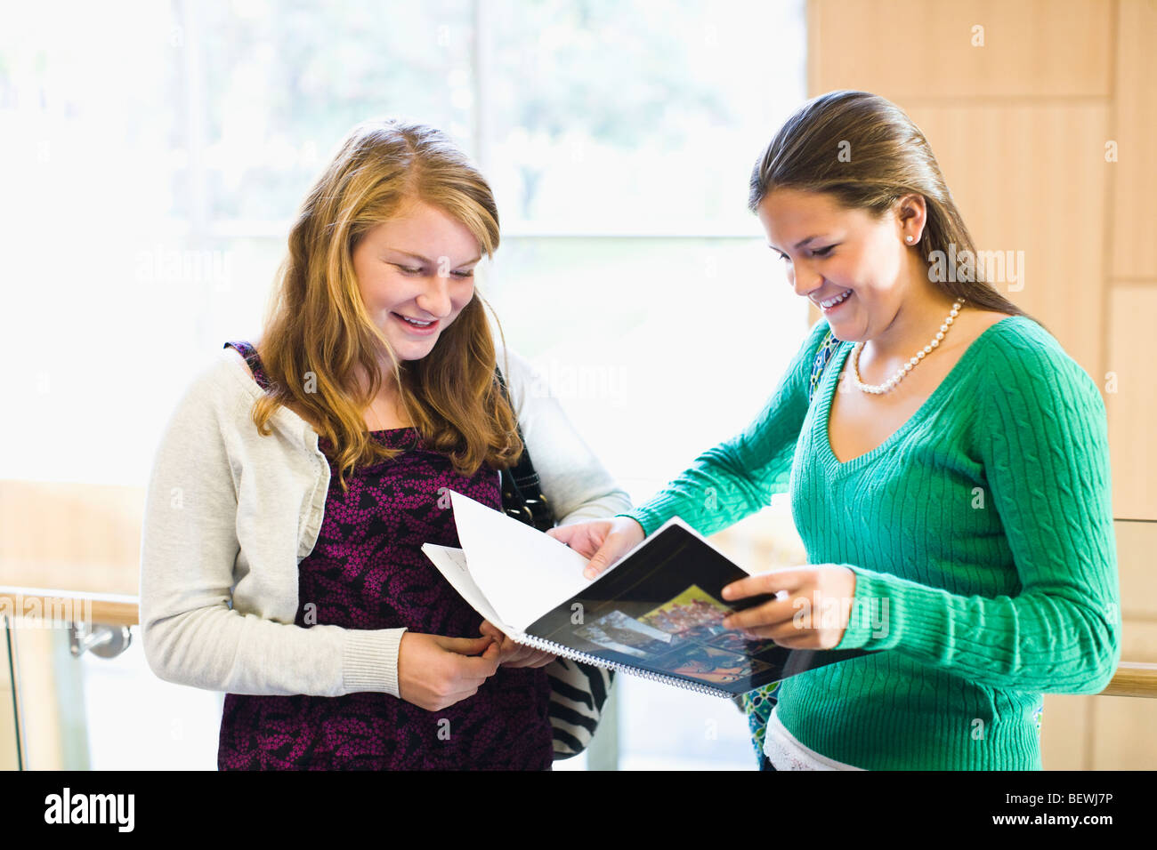 Two students reading a book Stock Photo - Alamy