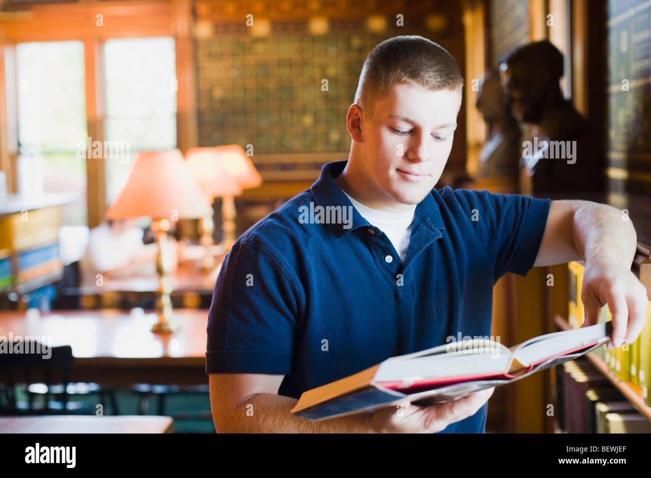 Student reading a book Stock Photo - Alamy