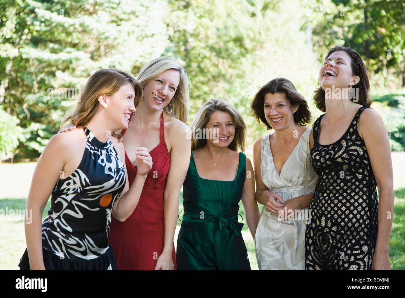 Five women standing in garden and smiling Stock Photo - Alamy