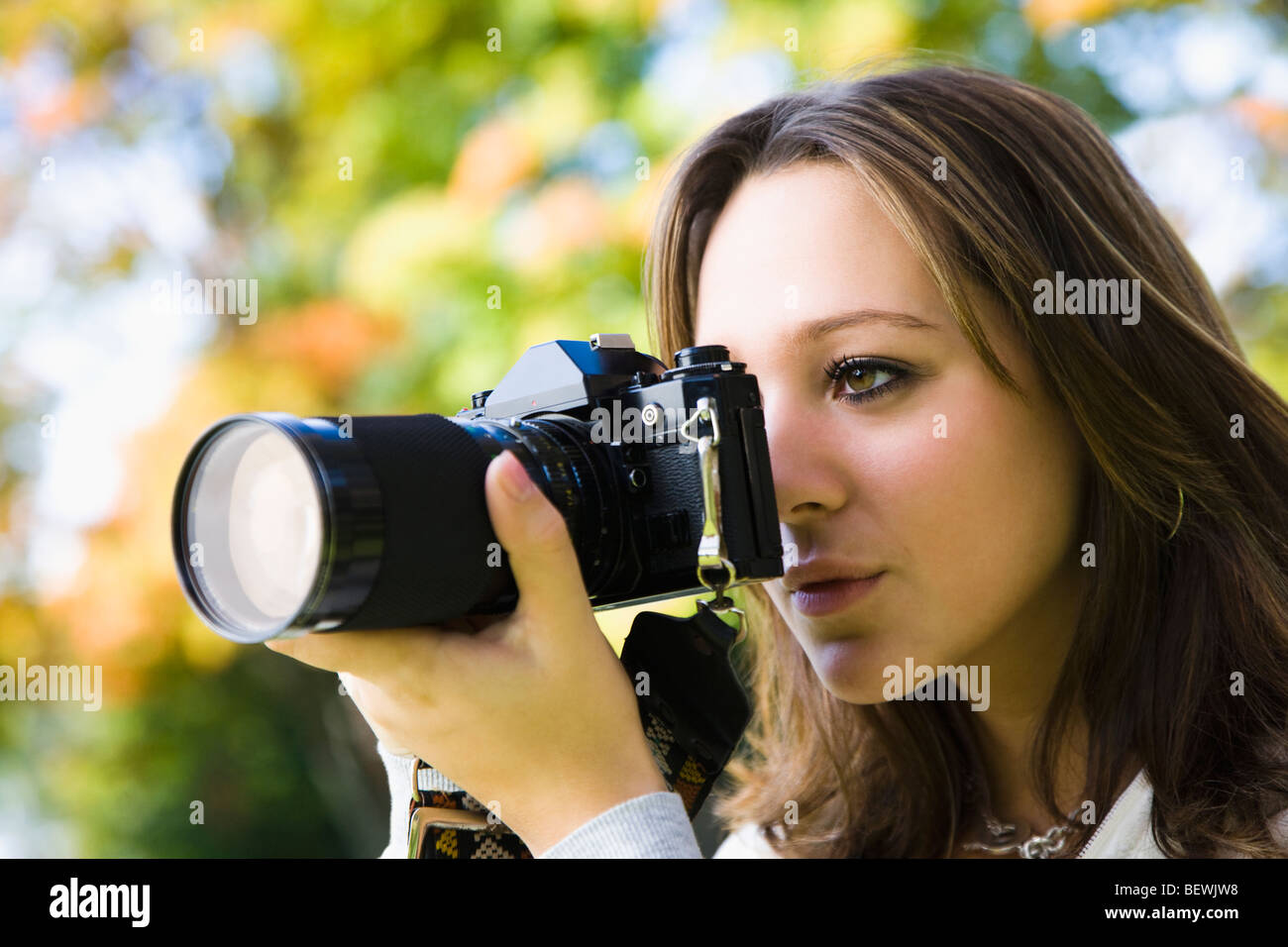 Teenage girl taking a picture with camera Stock Photo - Alamy