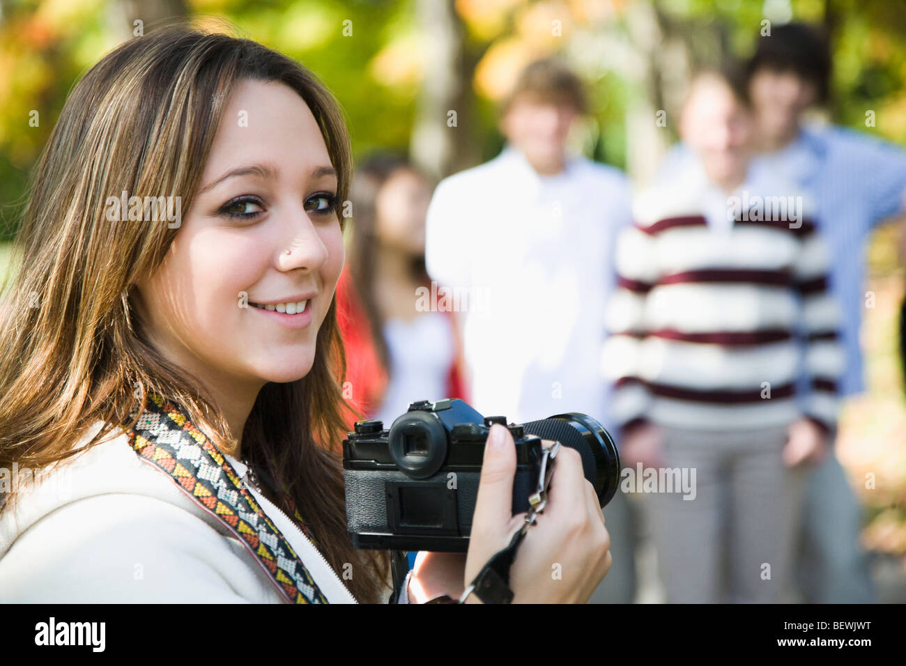 Student holding a digital camera and smiling Stock Photo - Alamy