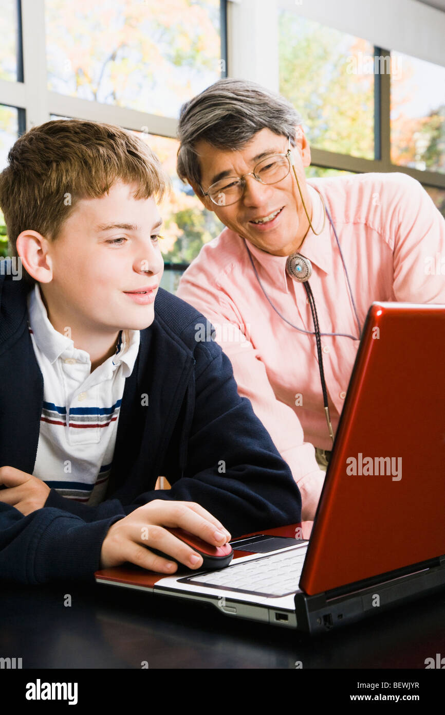 Teacher looking at a laptop on her desk hi-res stock photography and ...