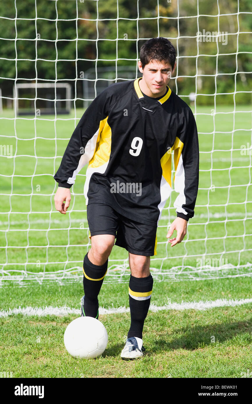 Portrait of a soccer player playing with a soccer ball Stock Photo - Alamy