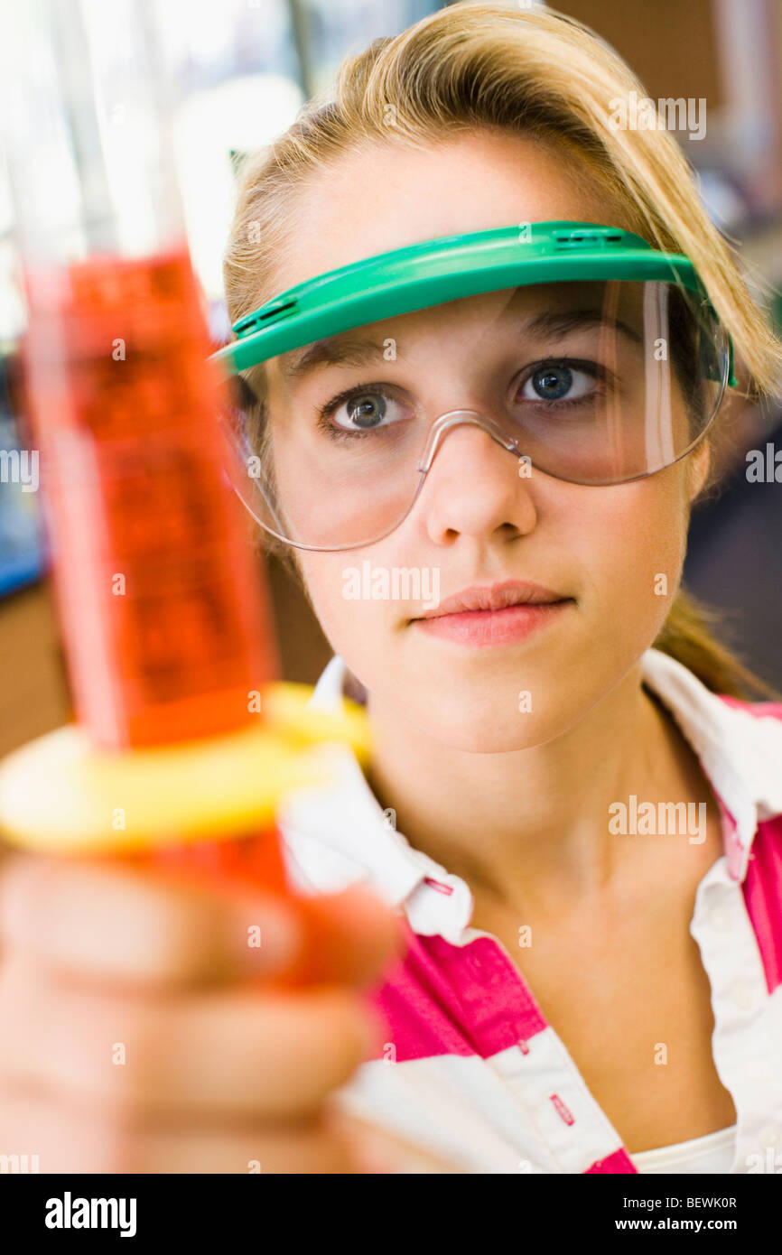 Student holding a graduated cylinder in a laboratory Stock Photo - Alamy
