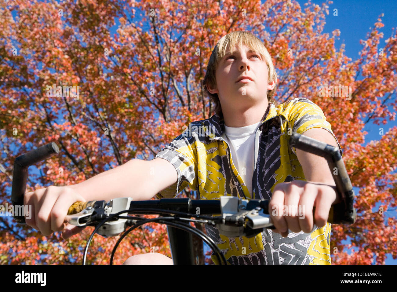 Low angle view of a teenage boy riding a mountain bike Stock Photo - Alamy